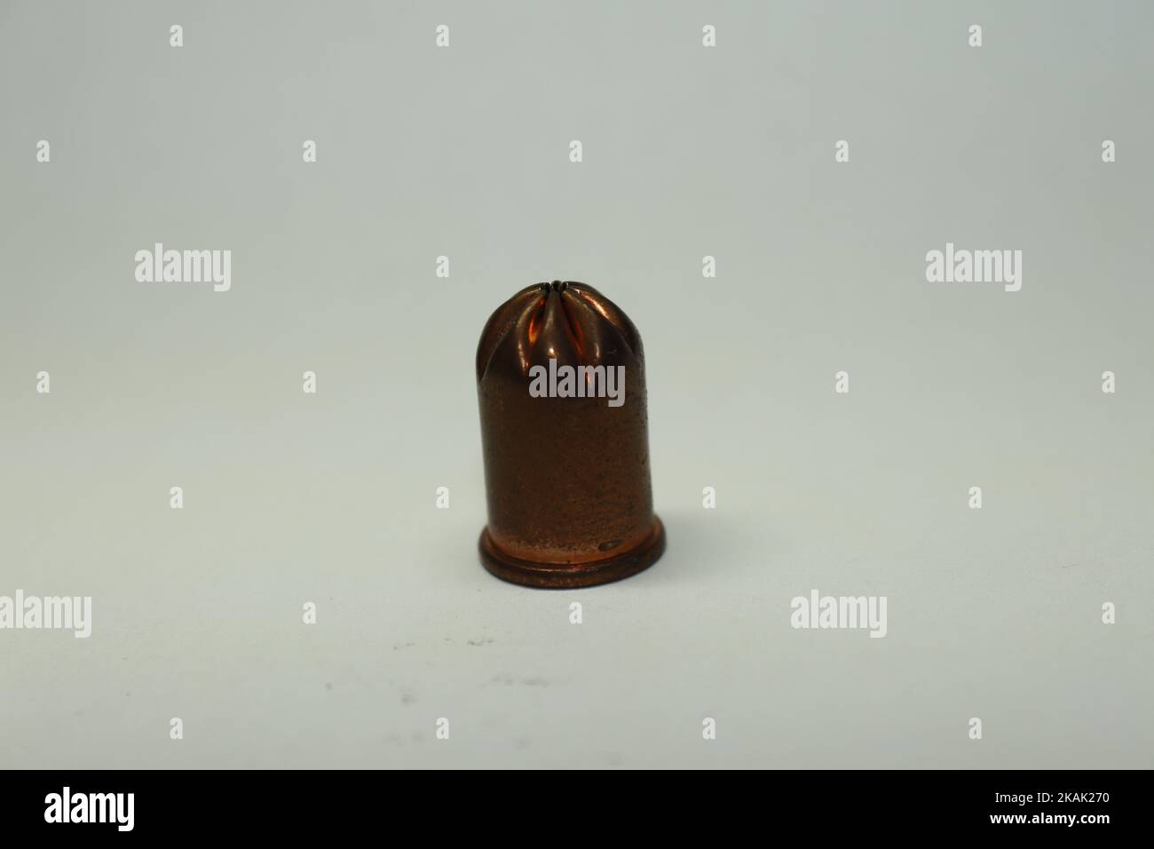 A closeup of a blank revolver cartridge isolated on a white background ...