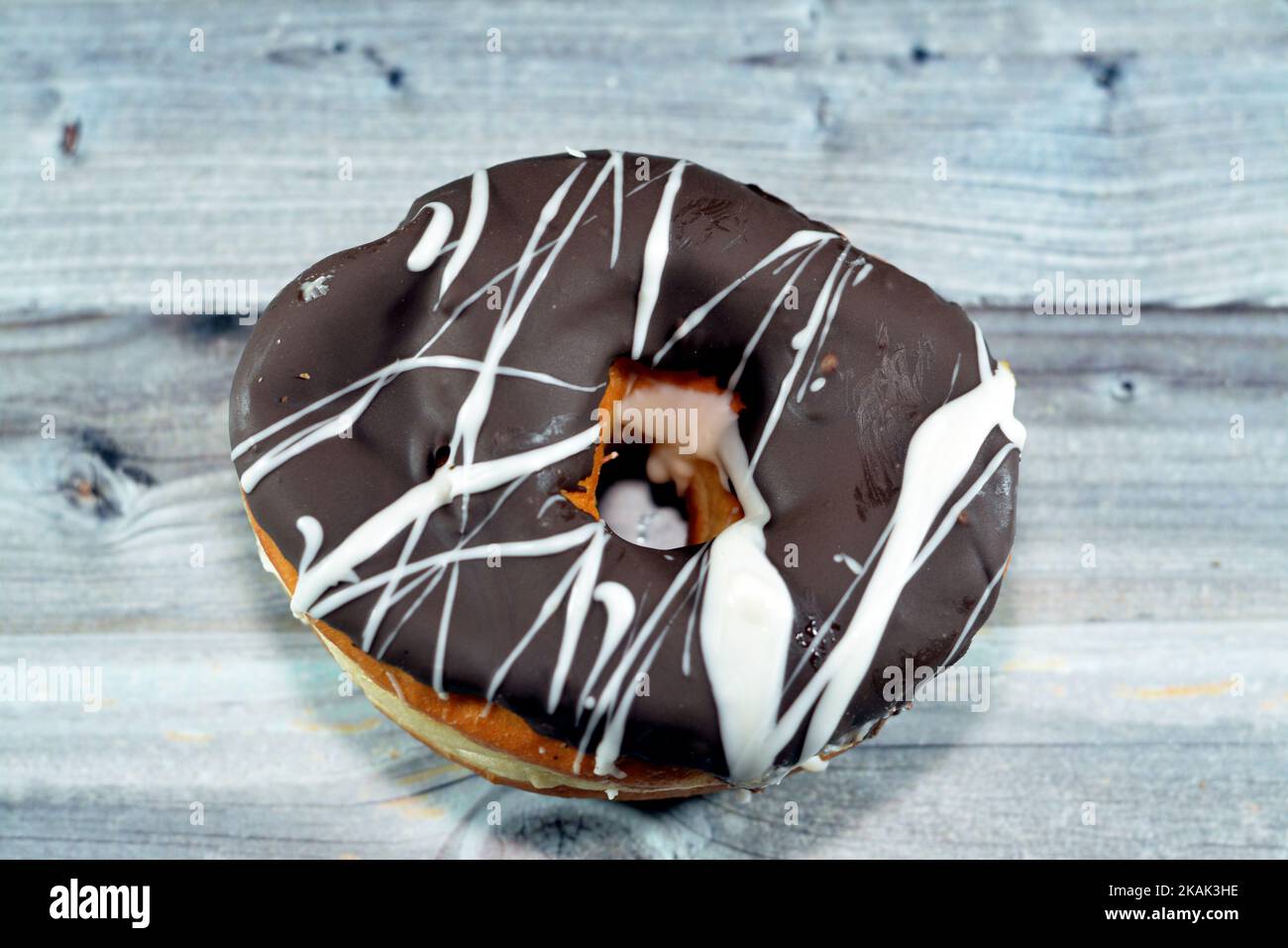 Brown and white chocolate ring donut, A glazed, yeast raised, American style ring doughnut, type ...