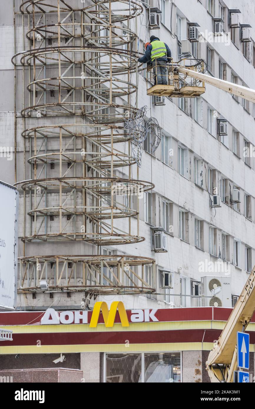 Workers change the front view of the previous McDonald's restaurant ...