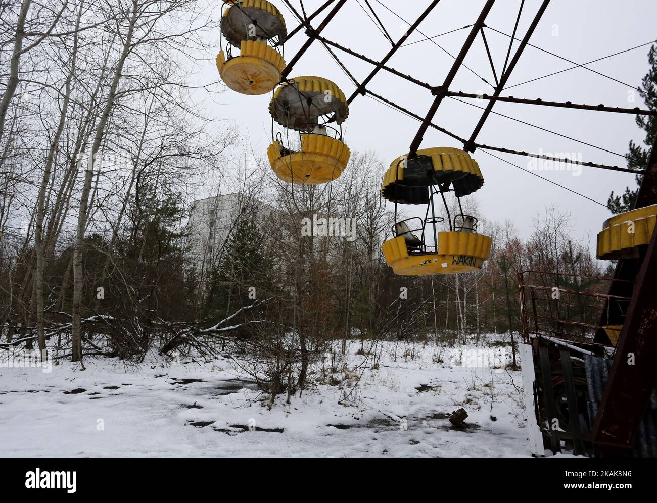 Visitors walk at the amusement park of the deserted city of Pripyat ...