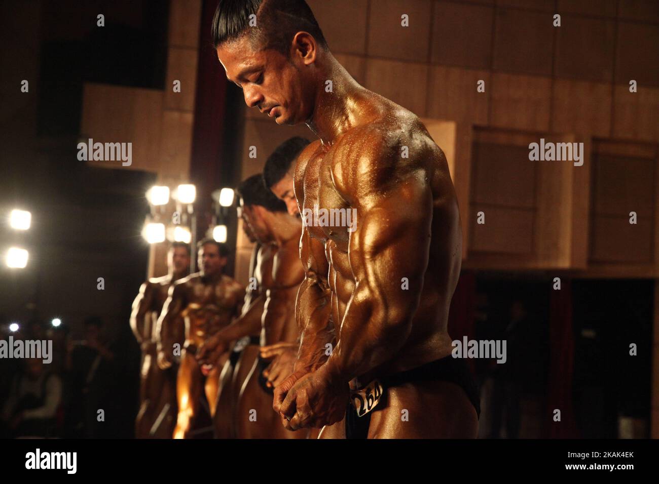 Bodybuilders posing infront of the judges in the Mr, in Dhaka ...