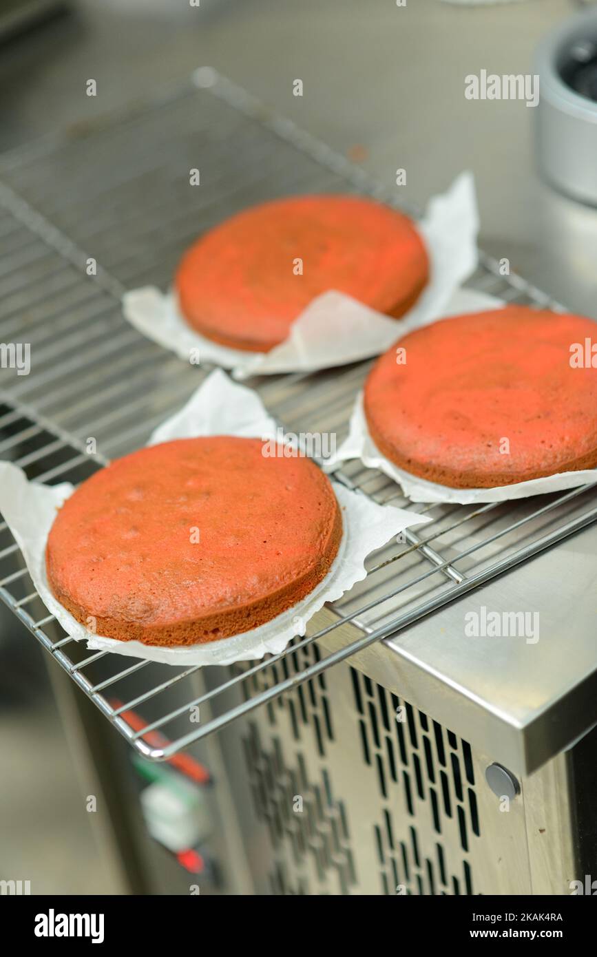 preparing layered red velvet cake , pieces in a trolley ready to ...