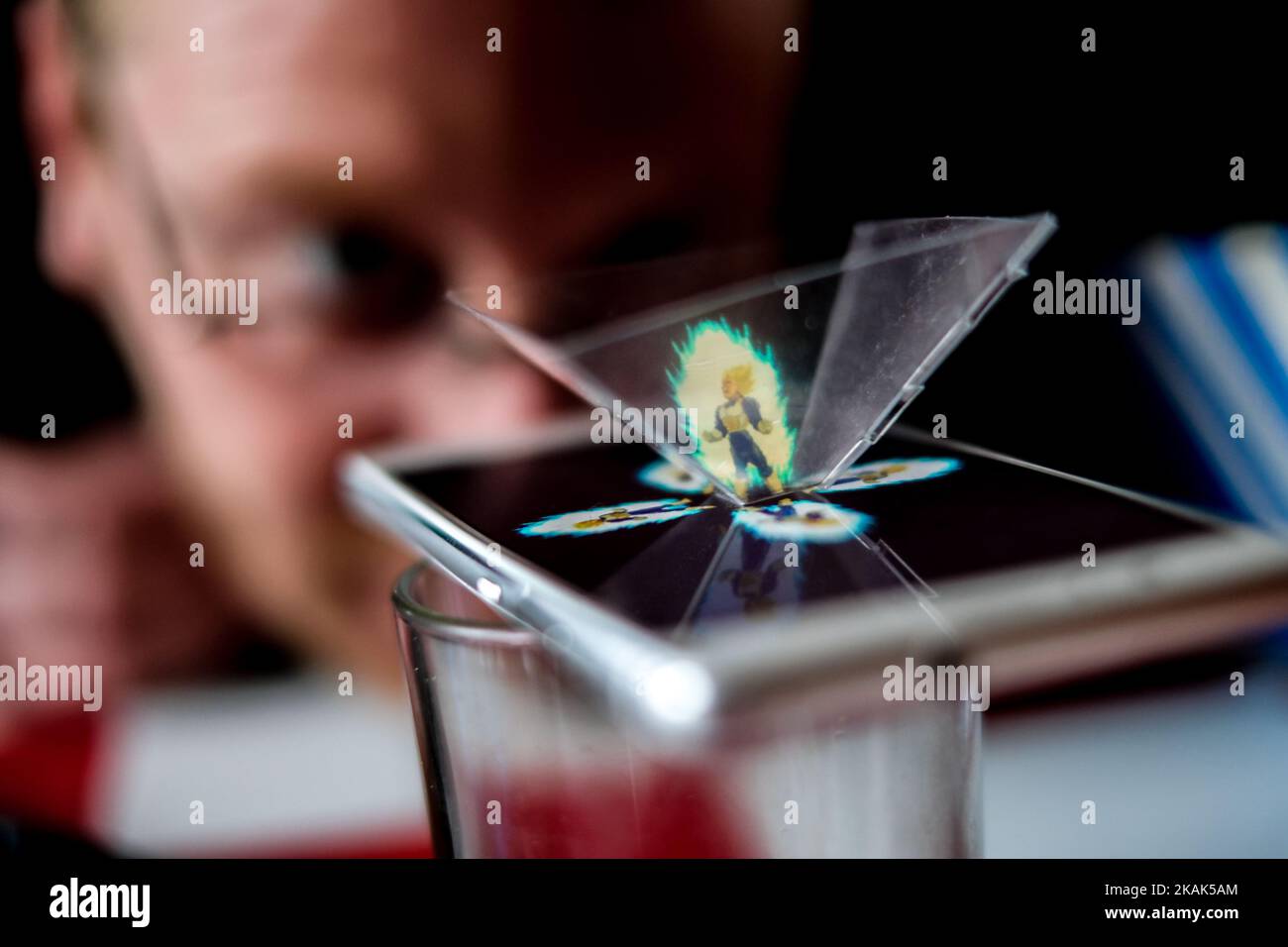 Illustration of a 3D Hologram projector with several comic strip ...