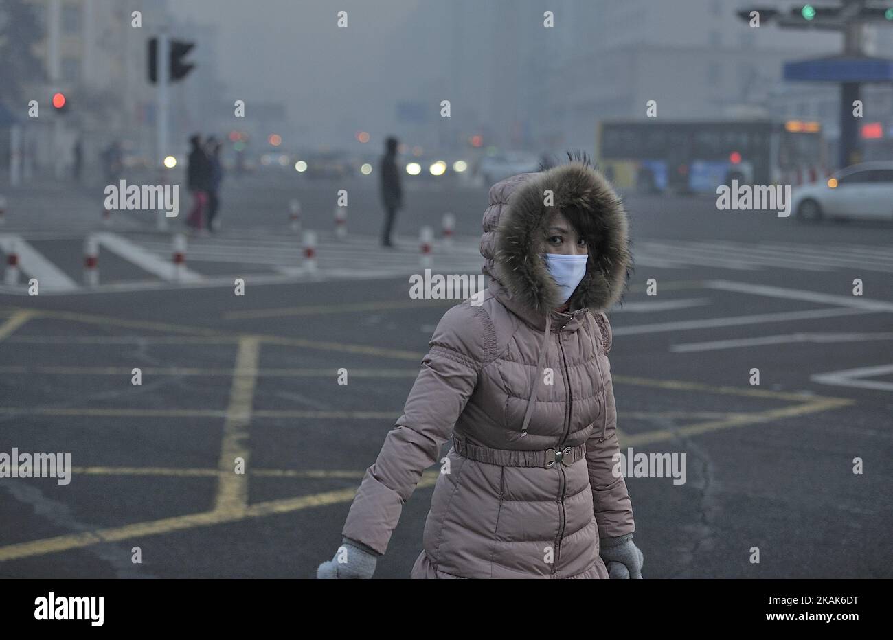 People walk on the street, wearing special mask to prevent breathing in ...