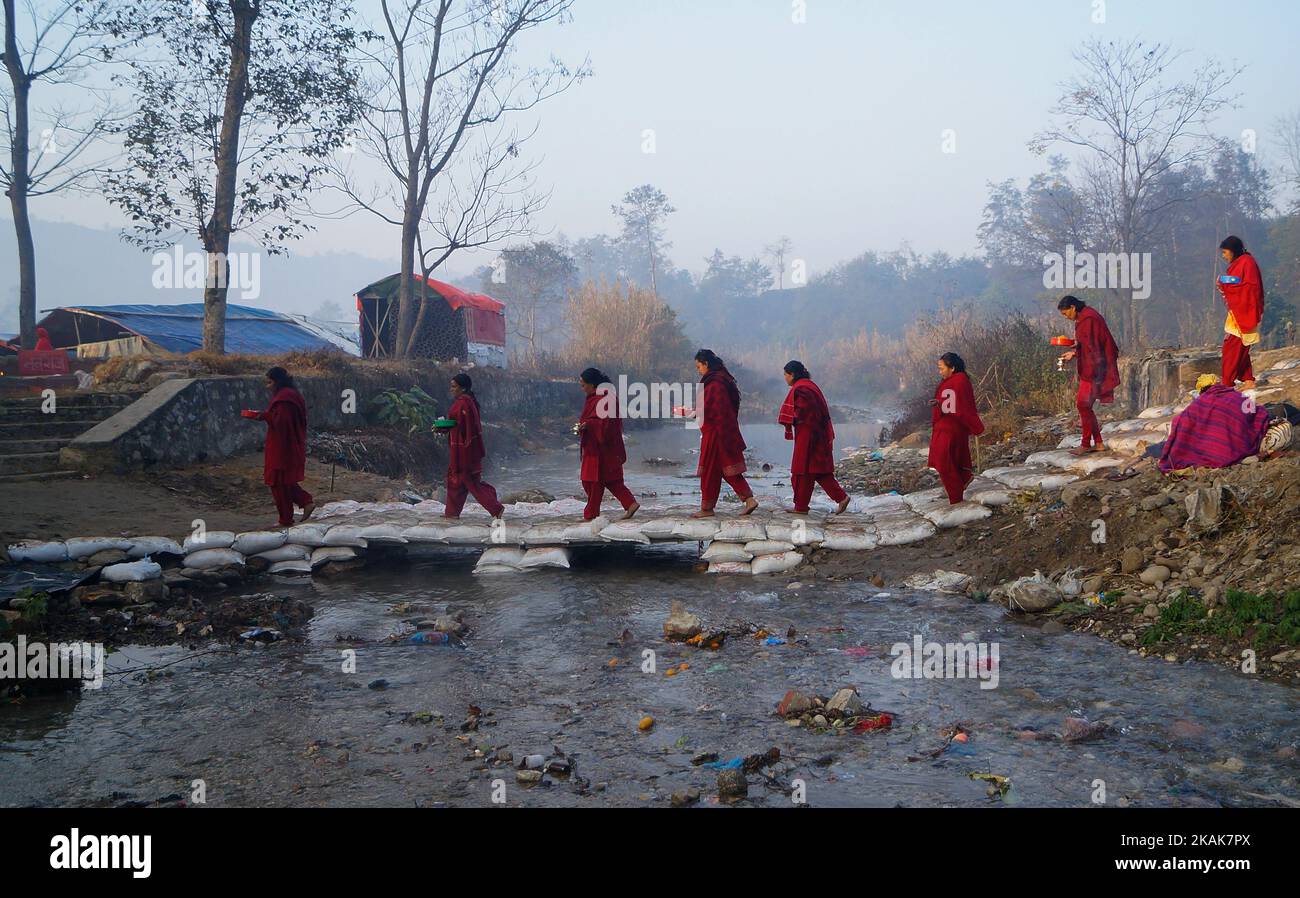 Nepalese Hindu devotees cross the Saali river to perform a ritual ...