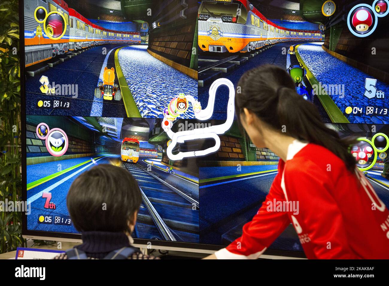 Japanese gamers trying the new game during the new console's unveiling ...