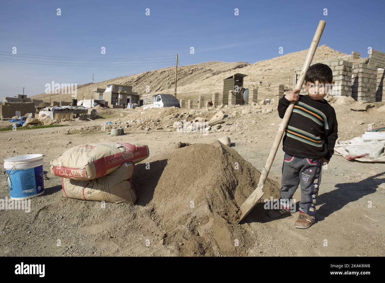 A shepherd tends his flock above the Yazidi village of Qalat Badre ...