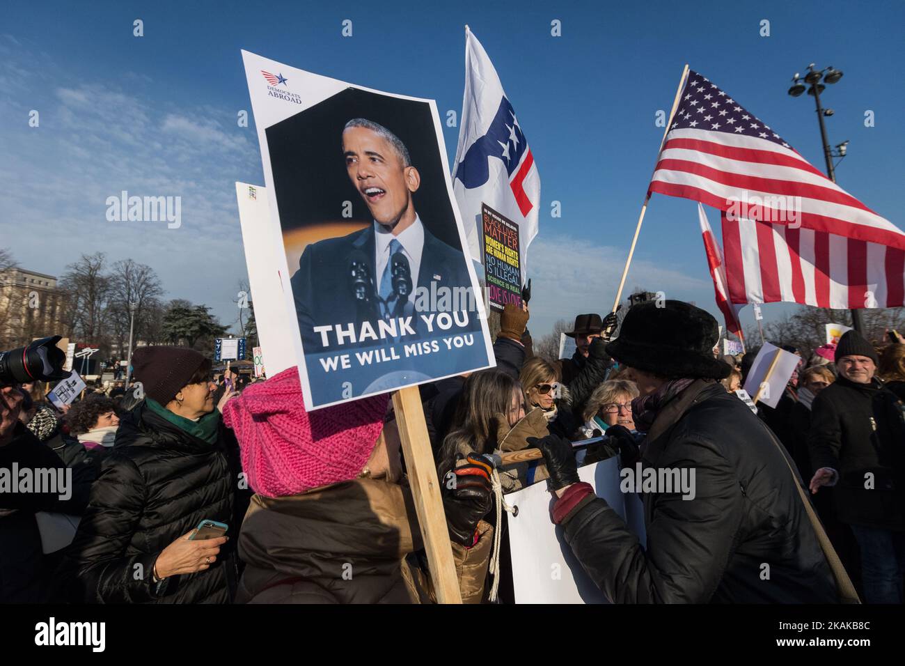 A demonstrator carries a sign featuring former U.S. President Barack ...
