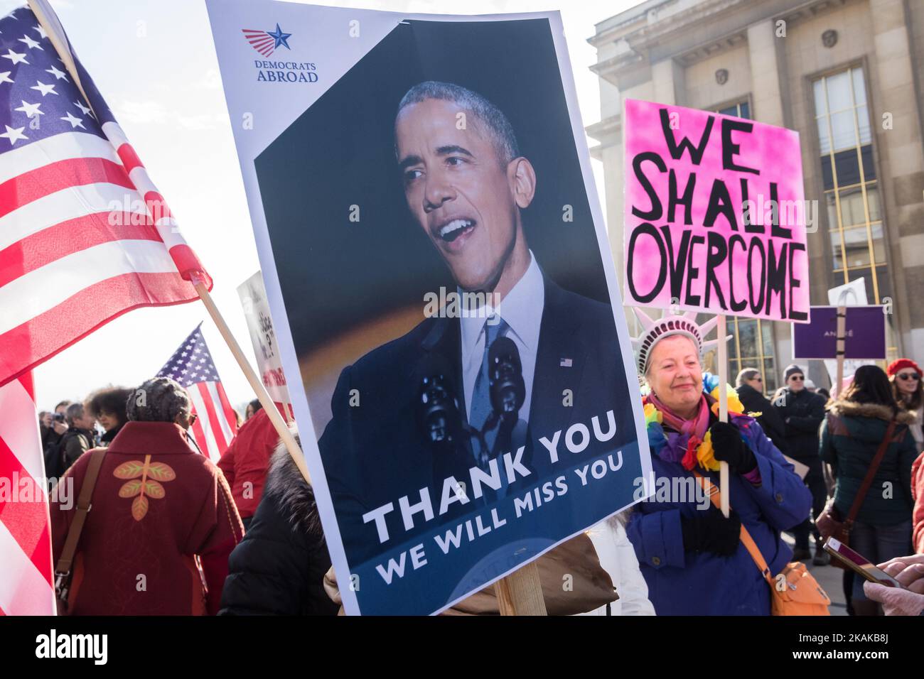 A demonstrator carries a sign featuring former U.S. President Barack ...