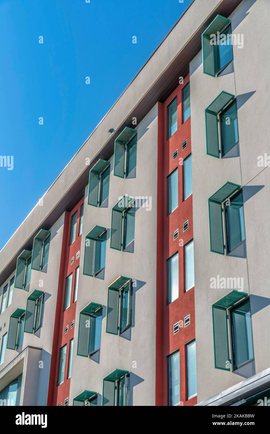 Exterior view of a modern apartment building with clear blue sky ...