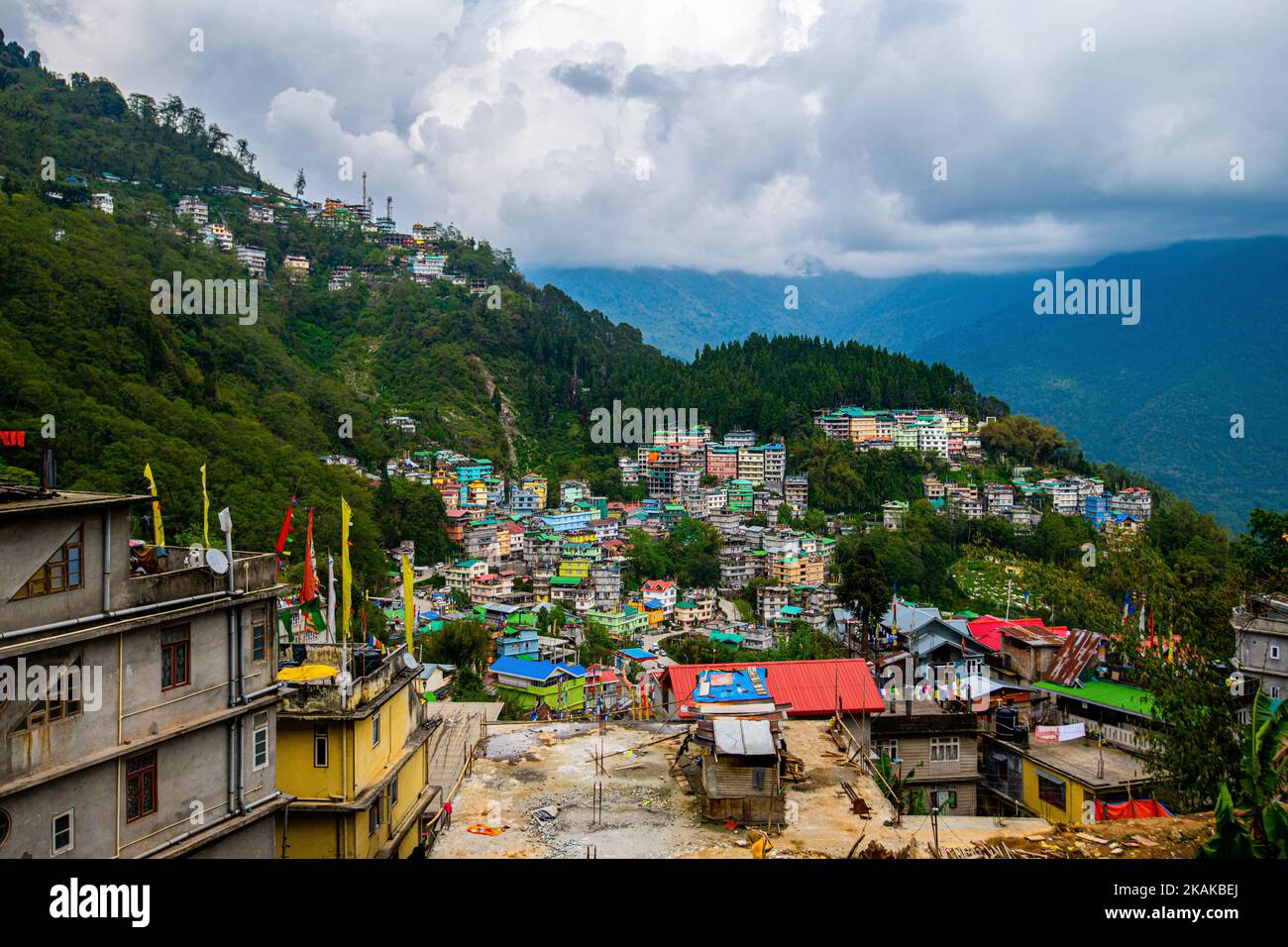 A drone view of Gangtok City with mountains covered with clouds and ...