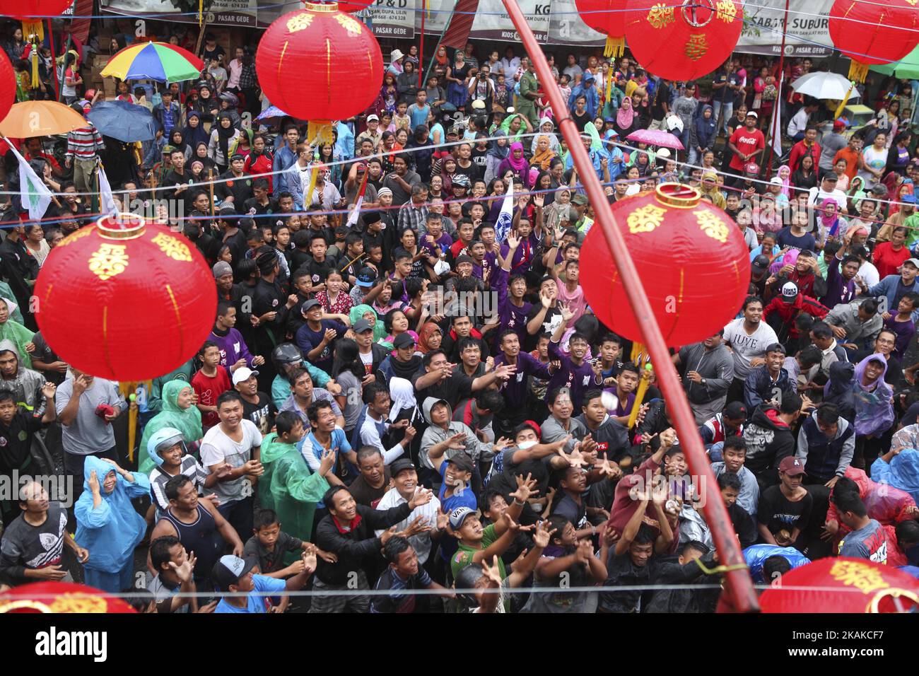 People scramble the traditional chinese cake during Grebeg Sudiro, a ...