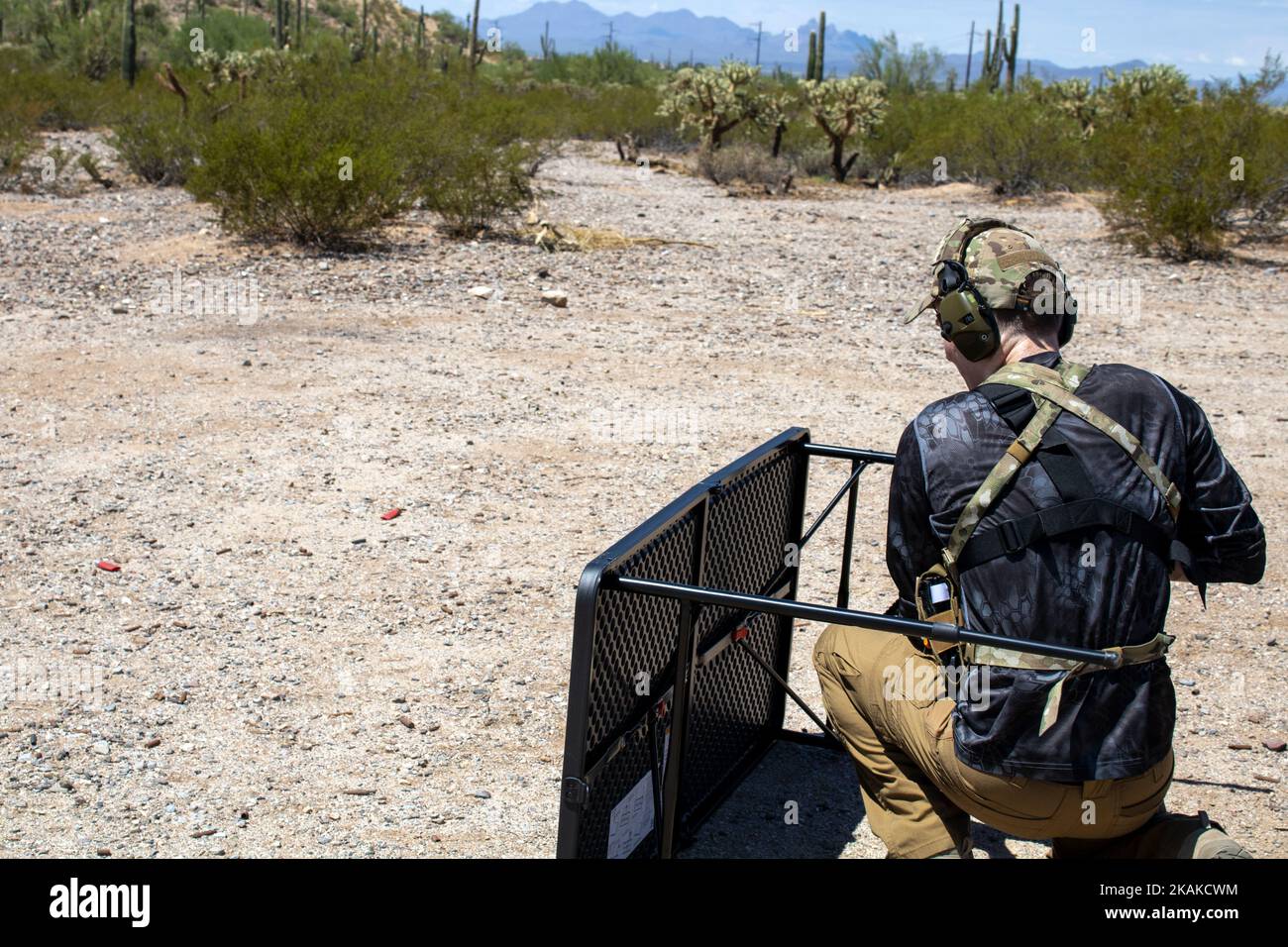 A Caucasian Man shooting with a heavily customized AR-15 Pistol SBR ...