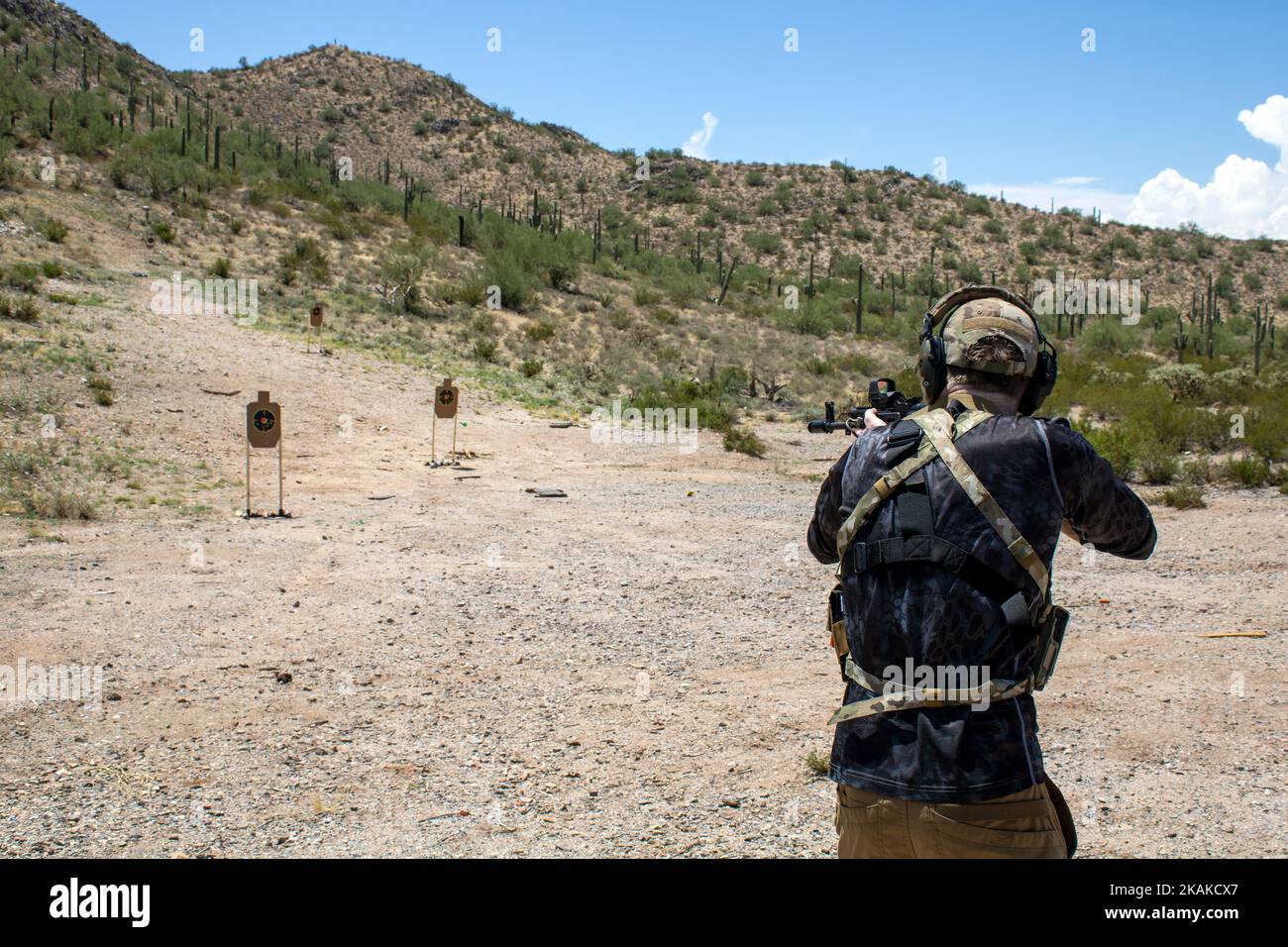 A Caucasian Man shooting with a heavily customized AR-15 Pistol SBR ...