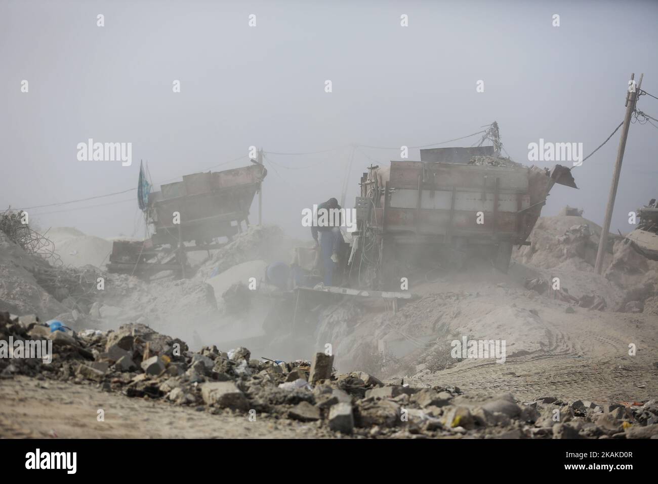 Palestinian workers at a factory that recycles rubbles of houses ...