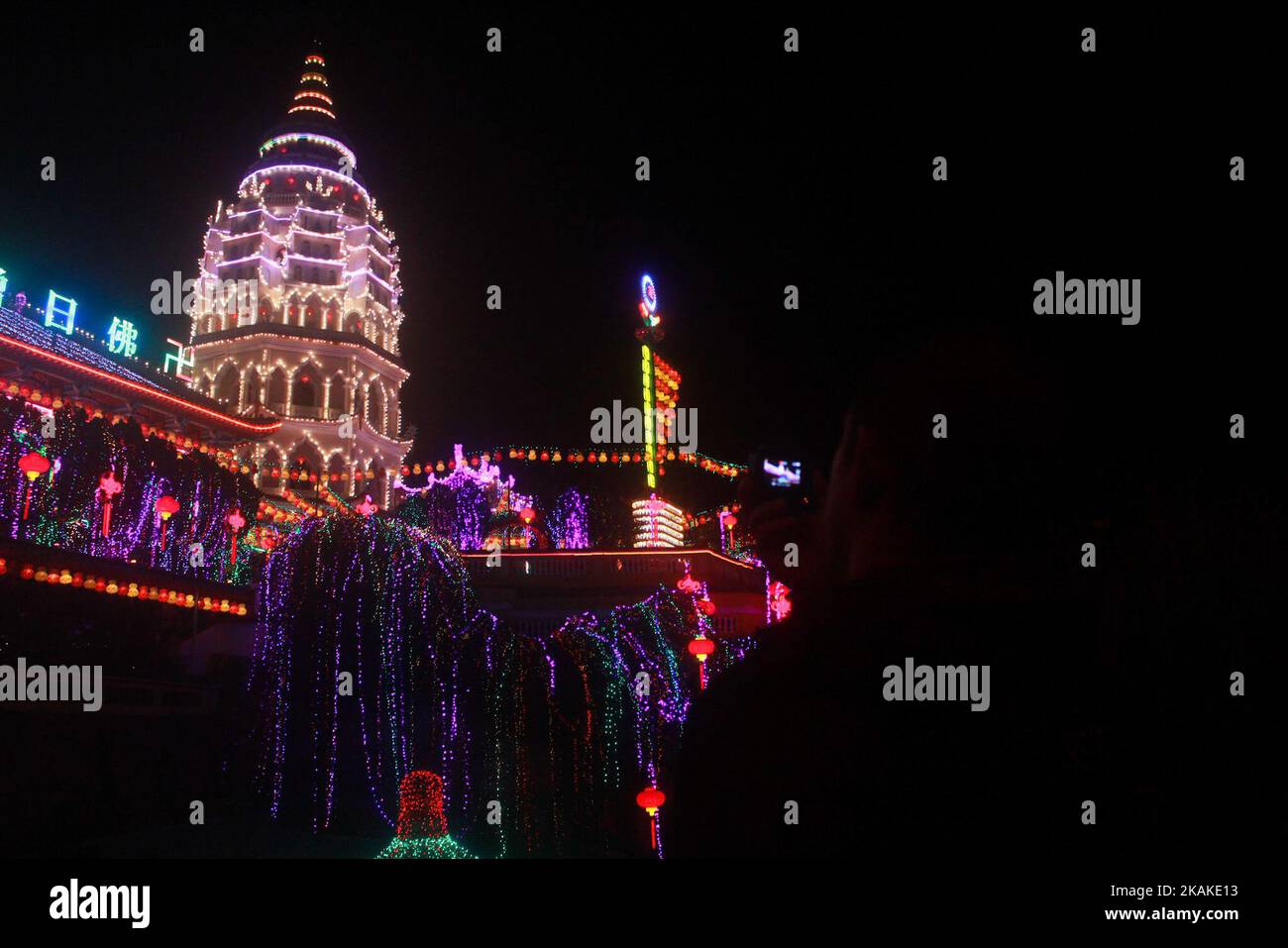 Visitor enjoying annual lighting display which showcases more than ...