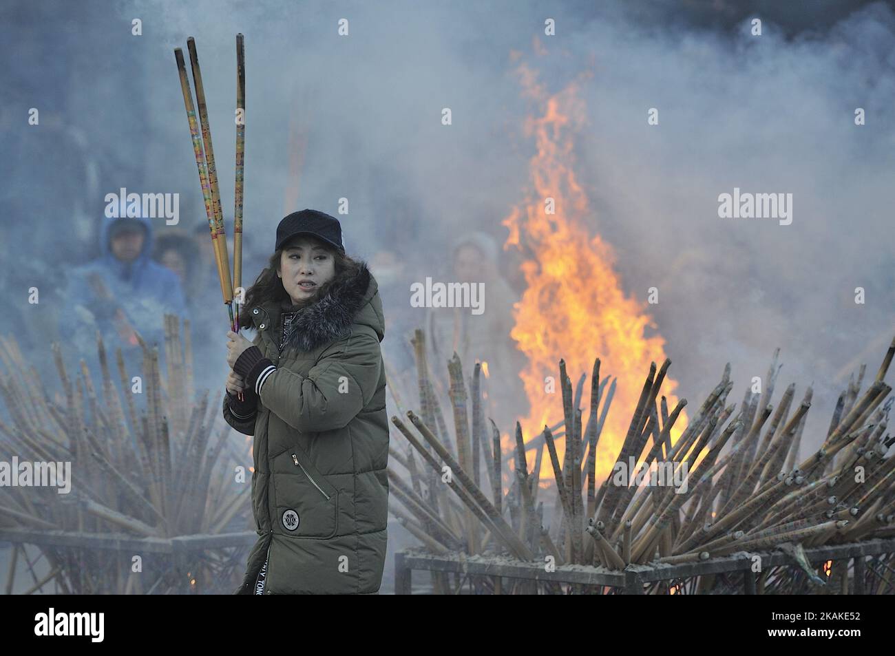 Chinese worshippers light incense as they pray at the Dacheng Temple on ...