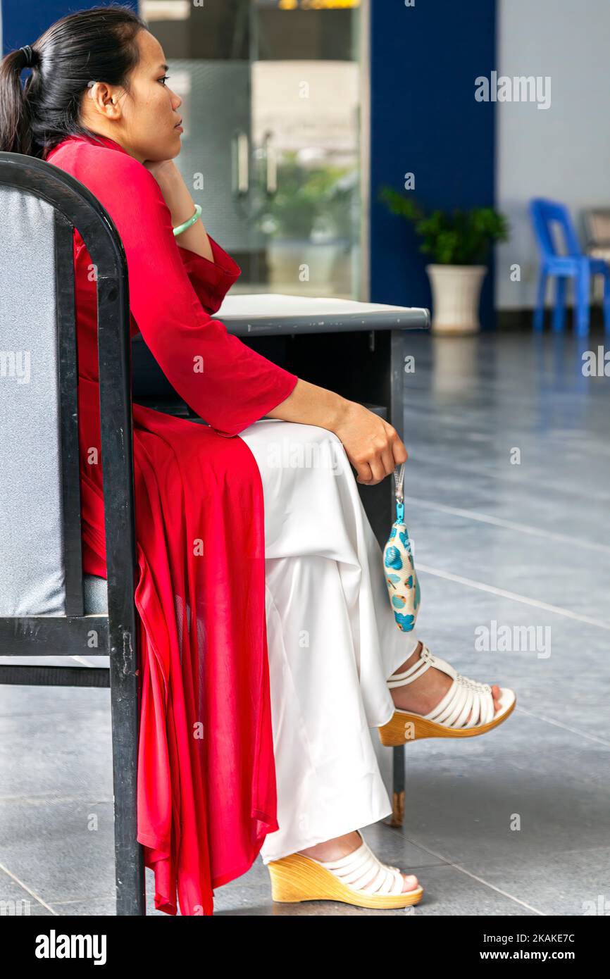 Vietnamese lady receptionist wearing ao dai at War Remnants Museum, Ho ...