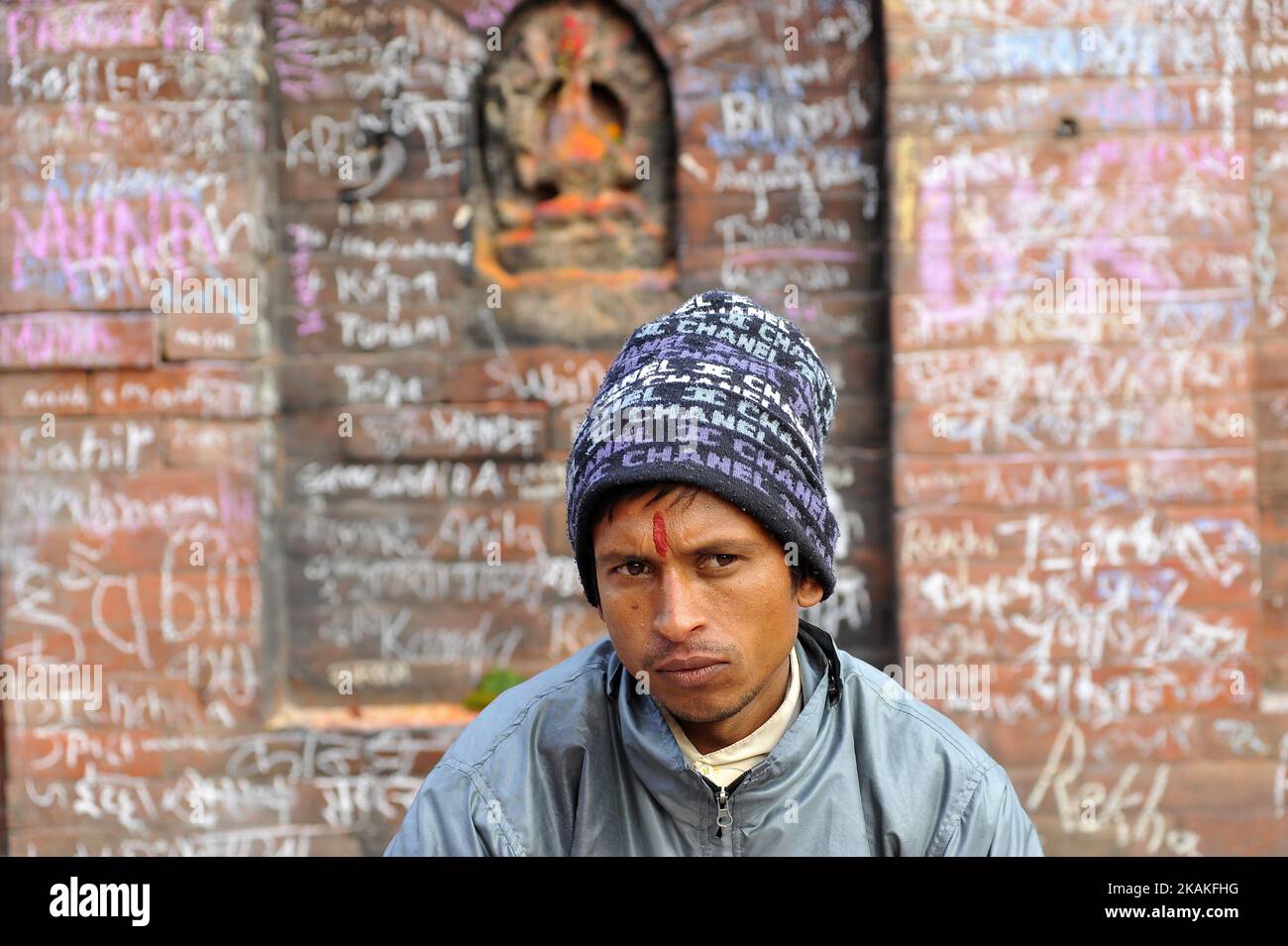 A Priest awaits devotees to offer red tika on forehead around the ...