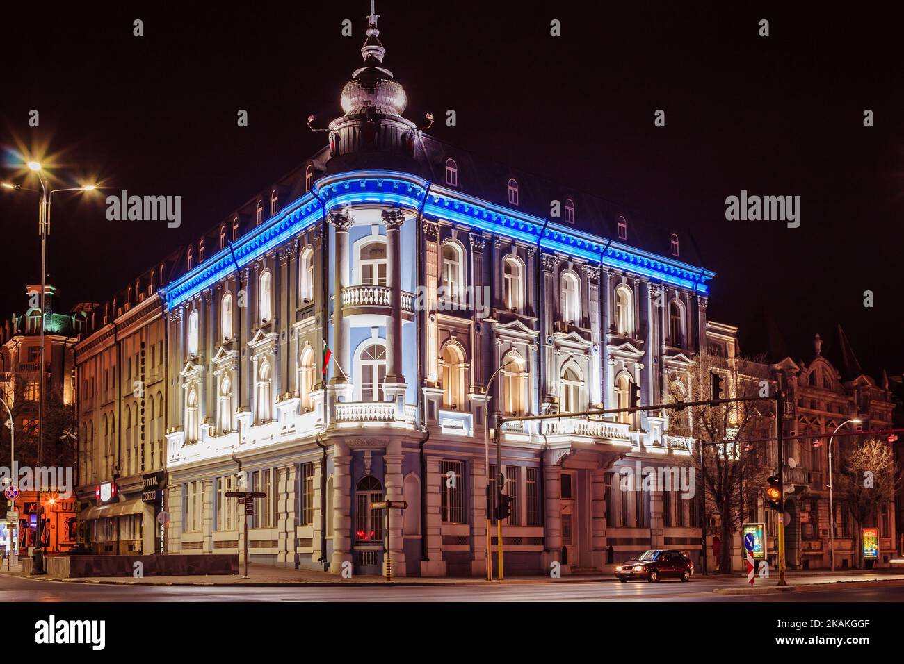 The exterior of the Navy club and a street with illuminated lights at ...