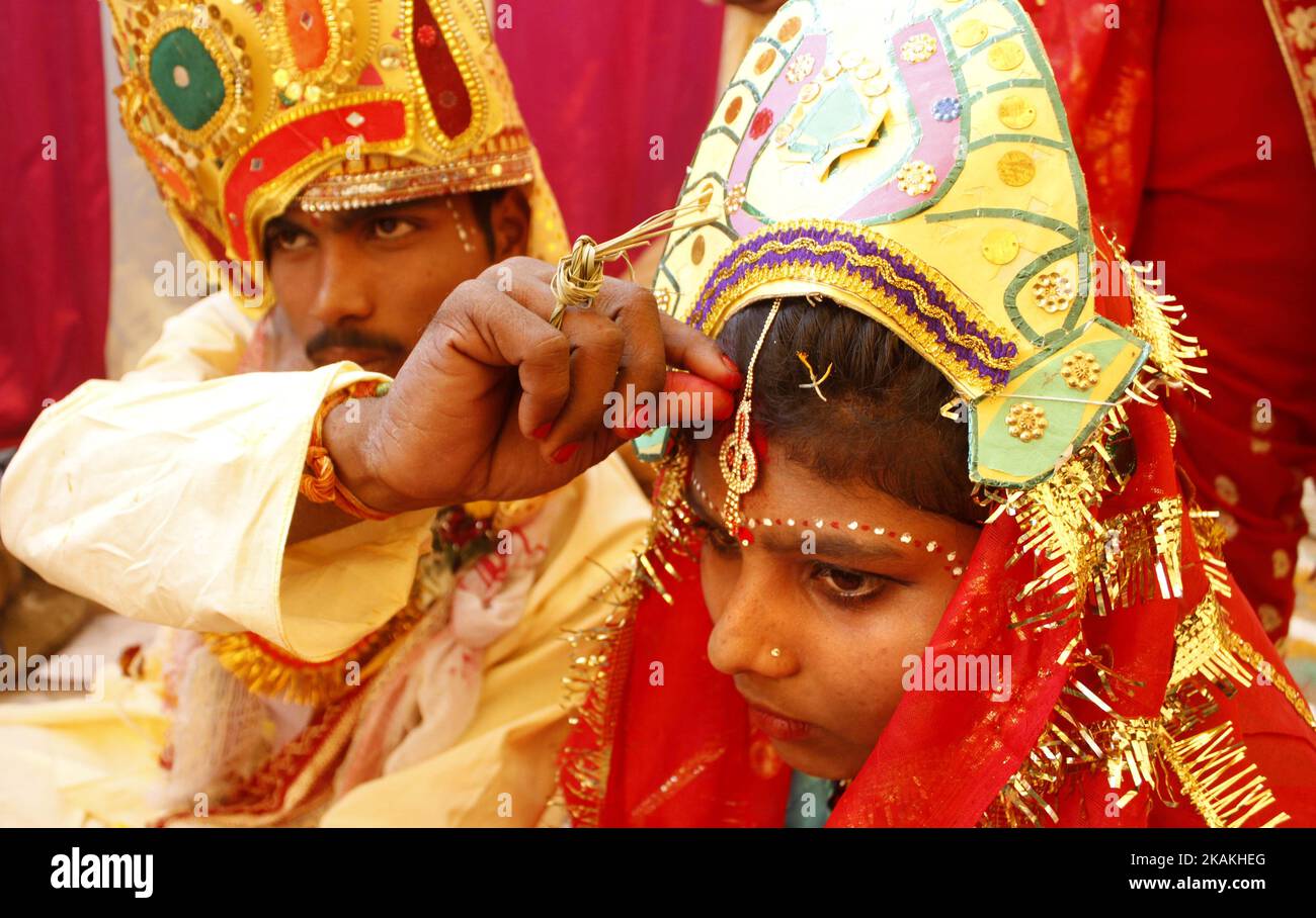 Bride and Grooms from below poverty line sits in the marriage rituals ...