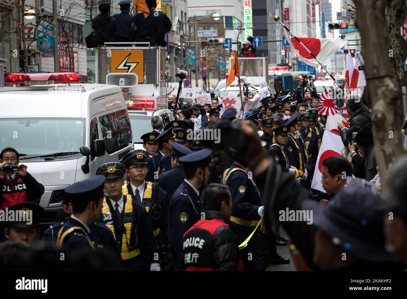 Chinese residents in Tokyo walk with placards to protest against the ...