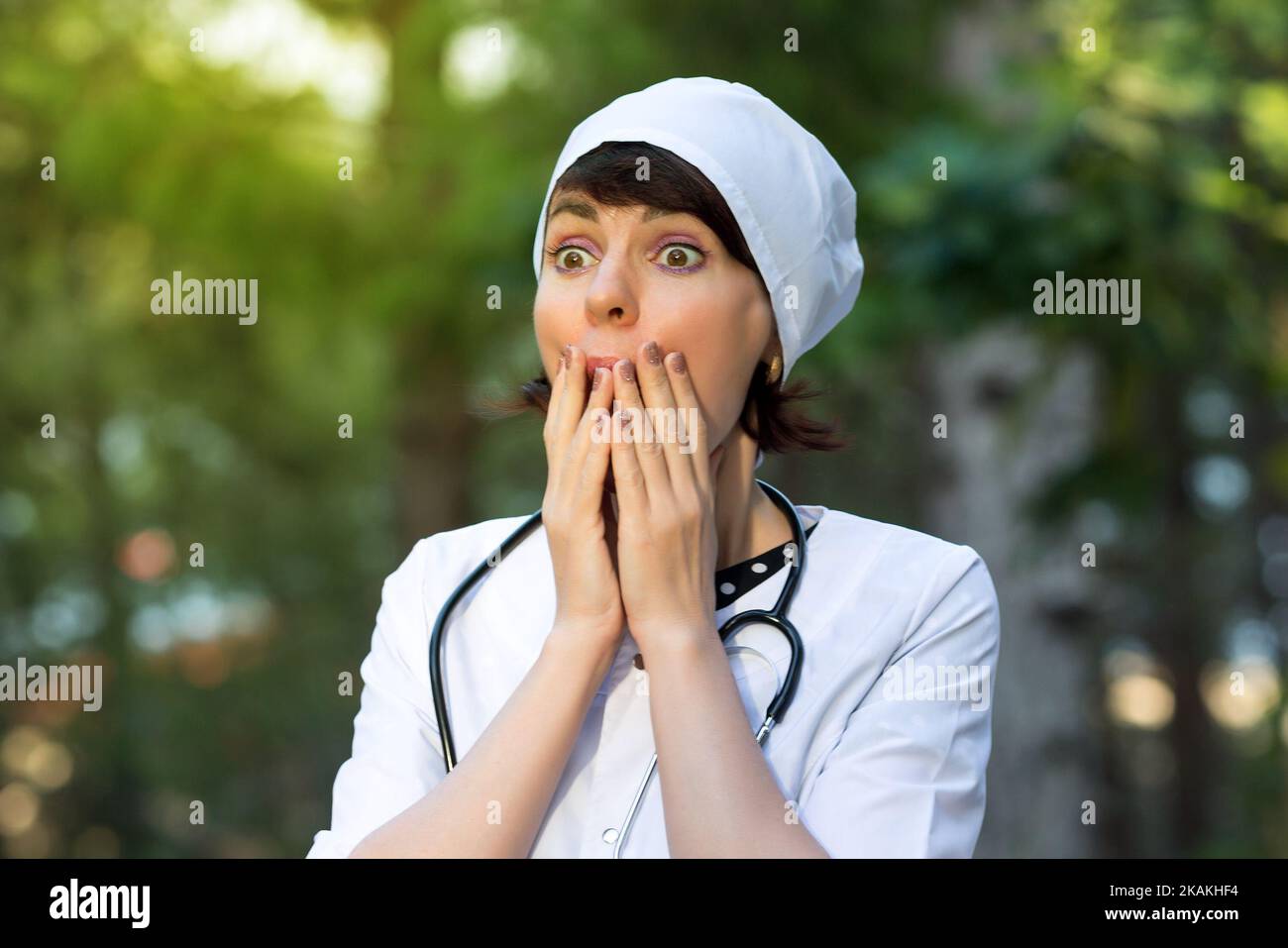 A female doctor white coat screams in fear after seeing something ...