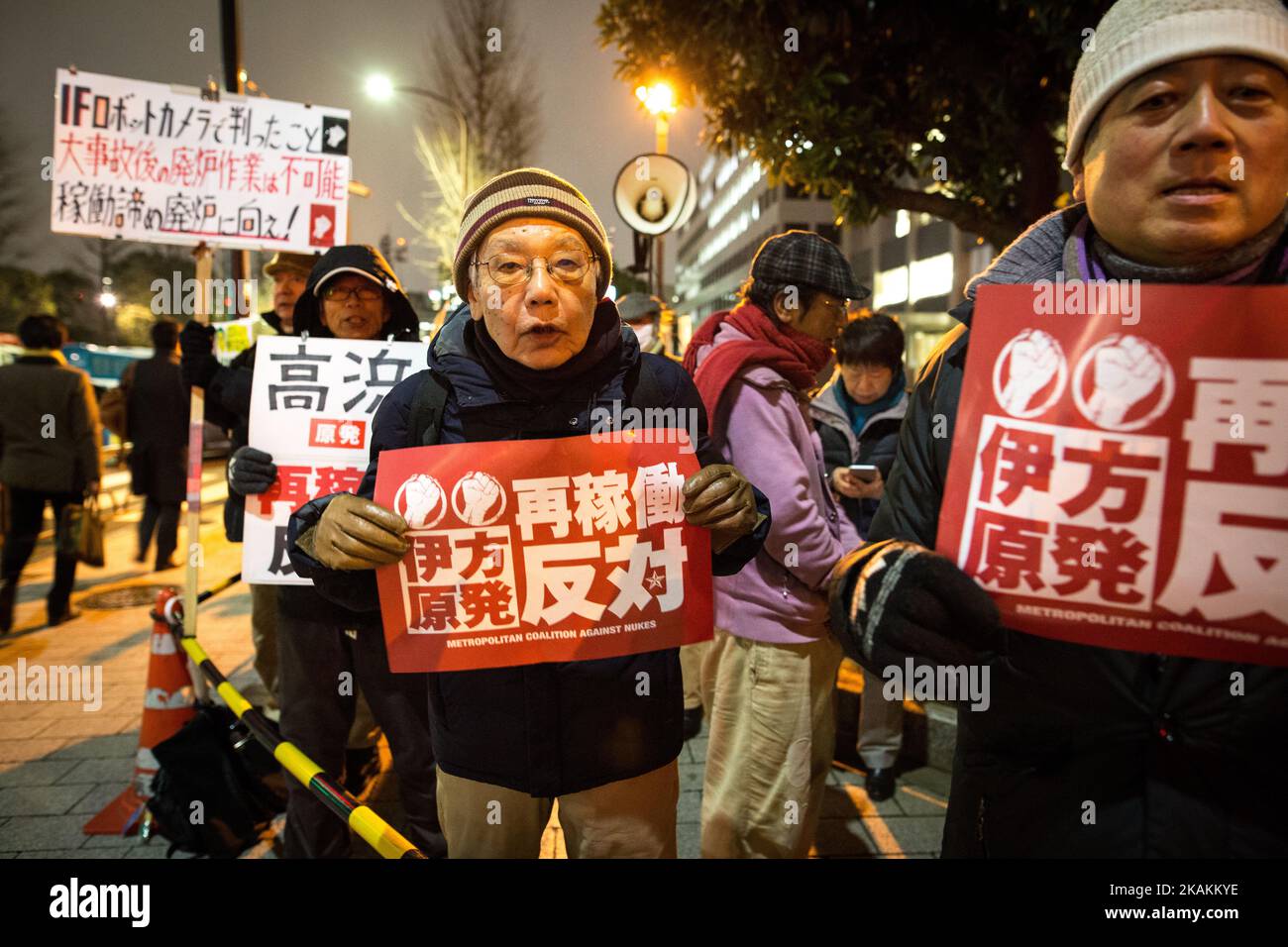 Anti-nuclear protesters hold "No nukes" placards during a protest ...