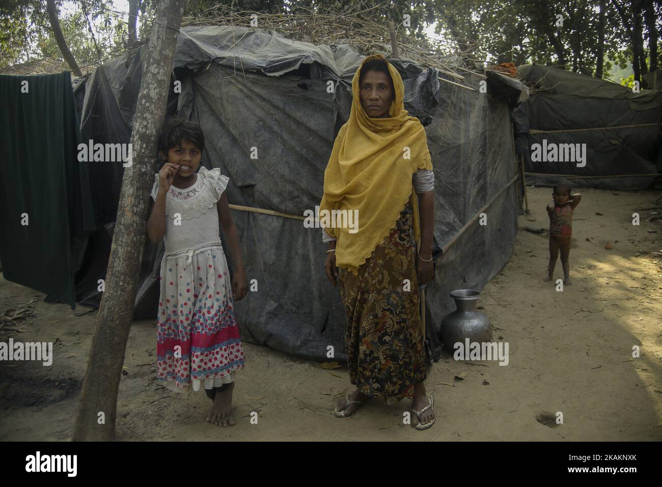 A Rohingya women stand in front of her house make from turpaulin sheet ...