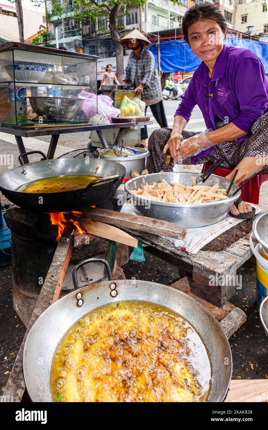 Vietnamese lady cooking food at roadside restaurant, Ho Chi Minh City ...