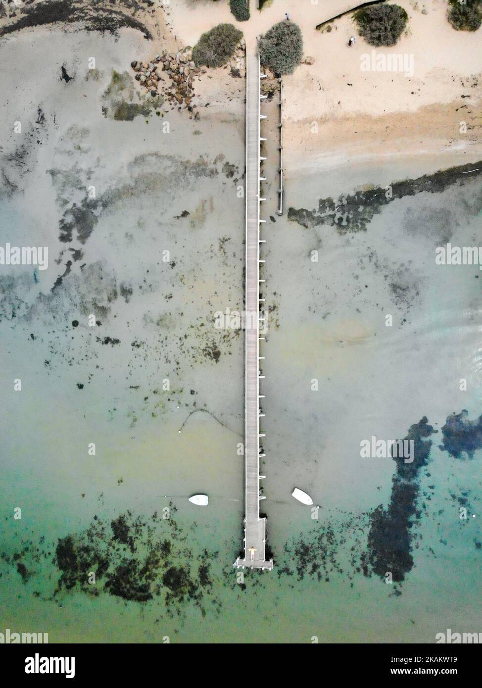 A vertical top shot of a long pier above the ocean Stock Photo - Alamy