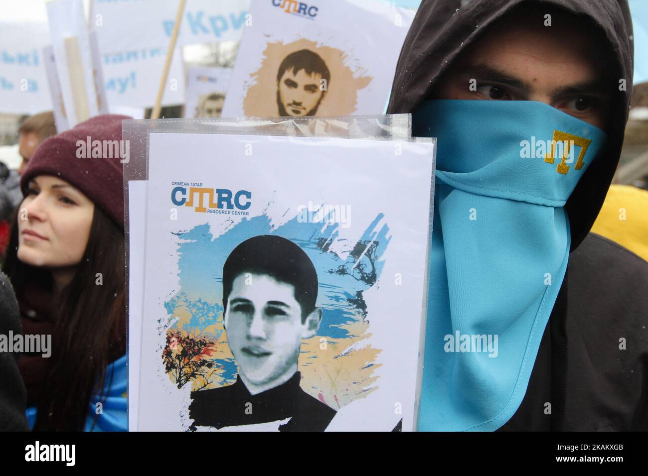 People hold portraits with the names of disappearing in Crimea after ...