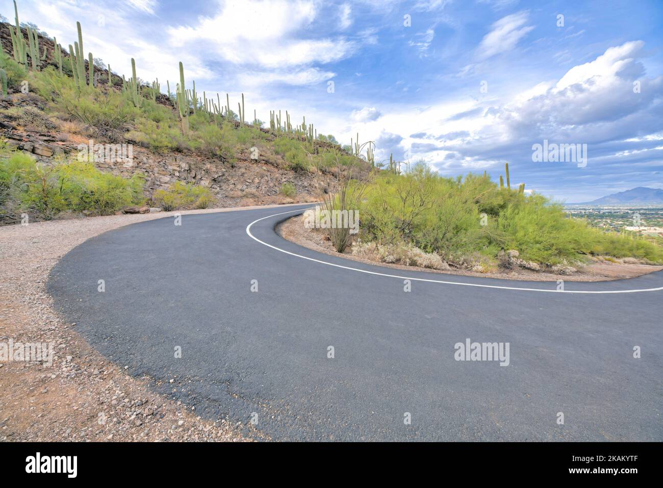 U-shaped concrete bike path and walkin pathway near a slope with ...