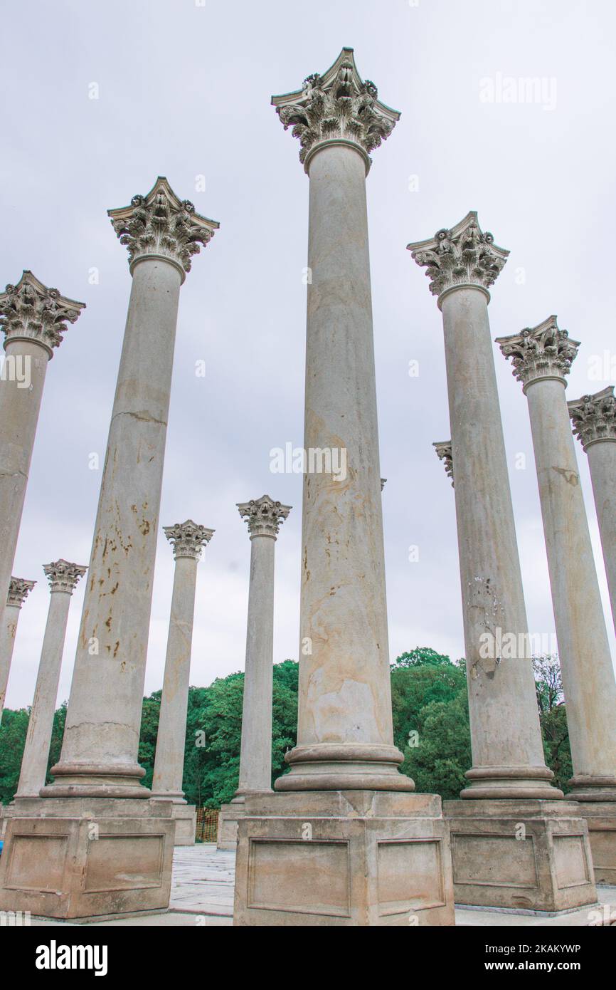 A low angle shot of National Capitol columns against a cloudy sky in ...