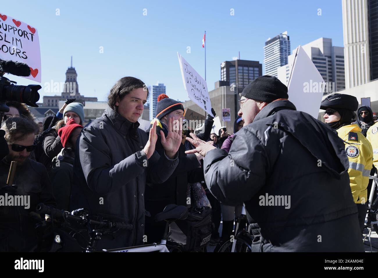 An Anti Muslim protester ( back towards the camera) arguing with a Pro ...