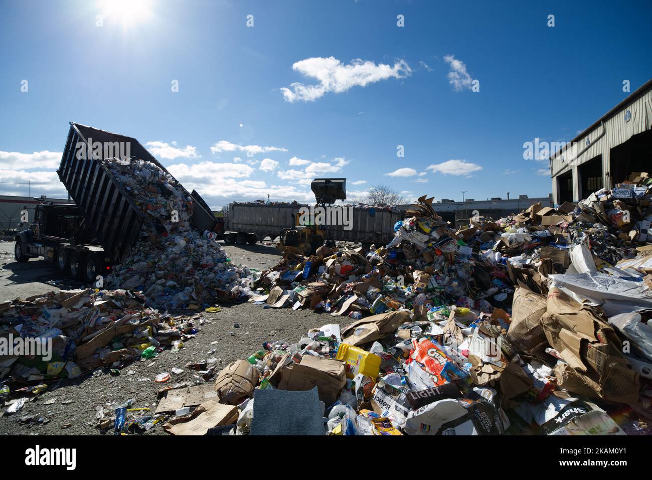 Trash truck tips its load of Municipal rubbish from a Philadelphia ...