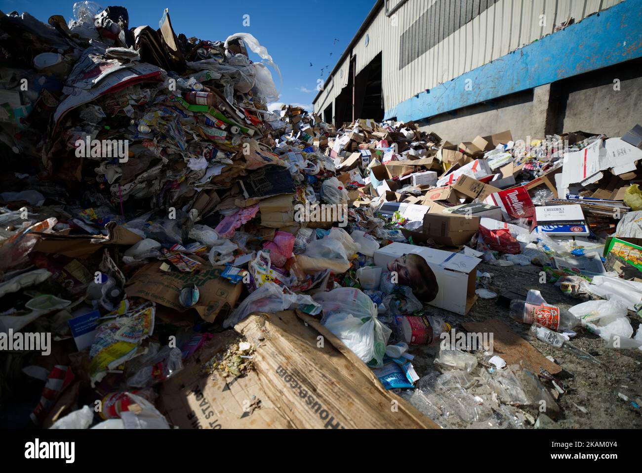 Before being fed into the process un-sorted rubbish is piled up on the ...