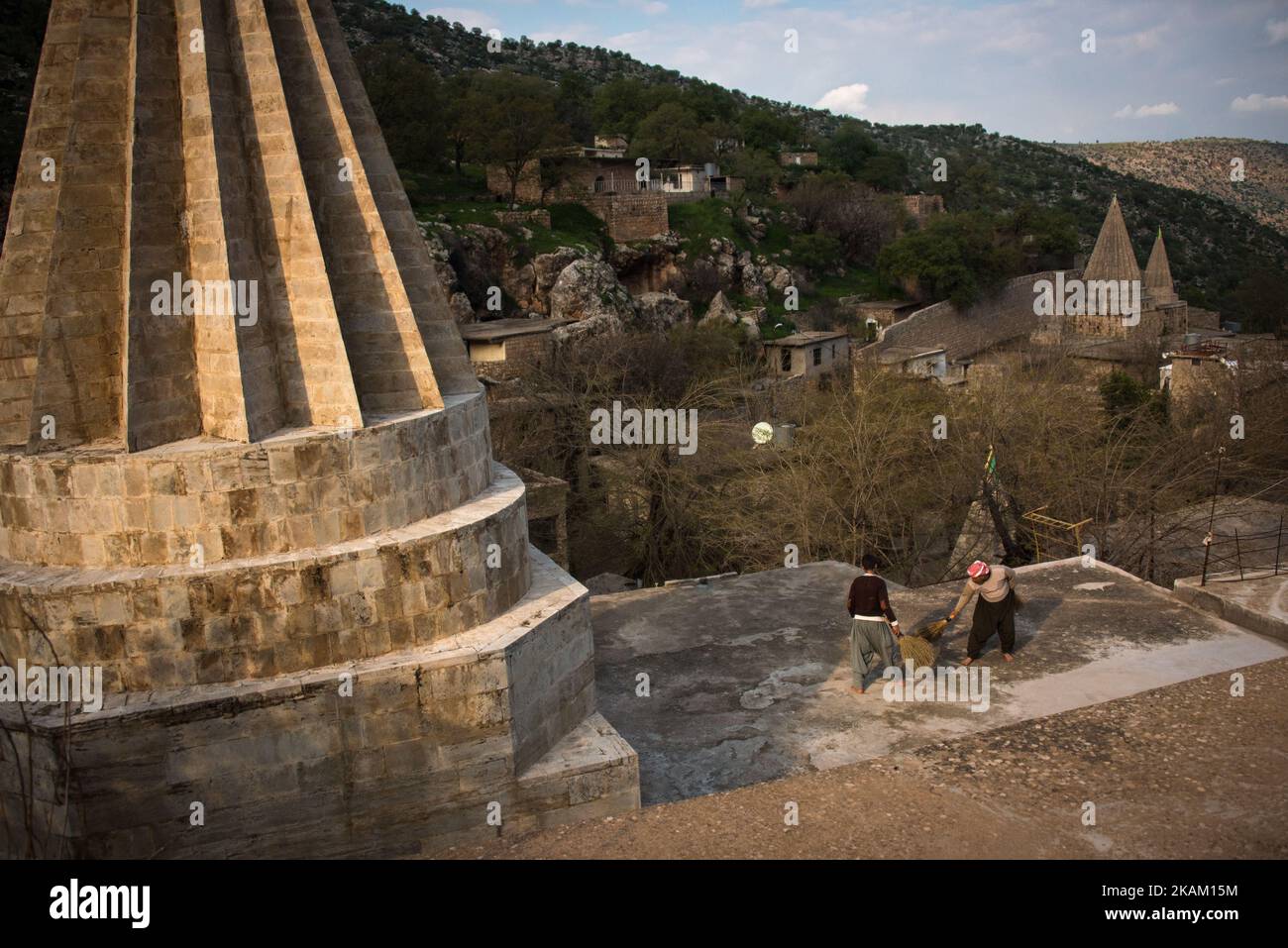 Yazidi men are seen performing a religious ritual at the entrance to ...