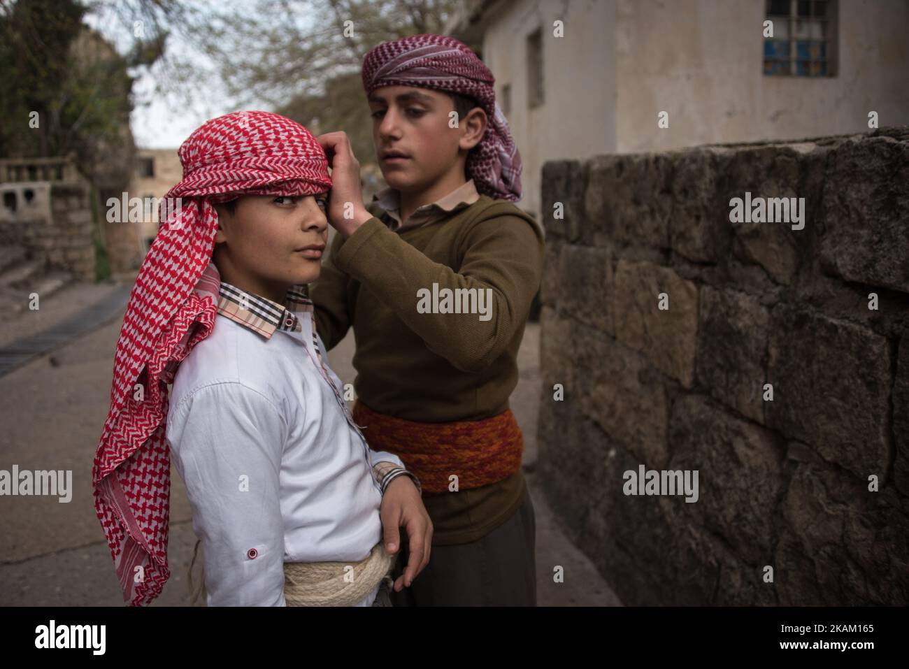Yazidi boys are seen performing a religious ritual while attending ...