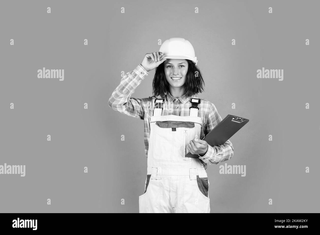 Built with excellence. carpenter assistant wear protective helmet. girl ...