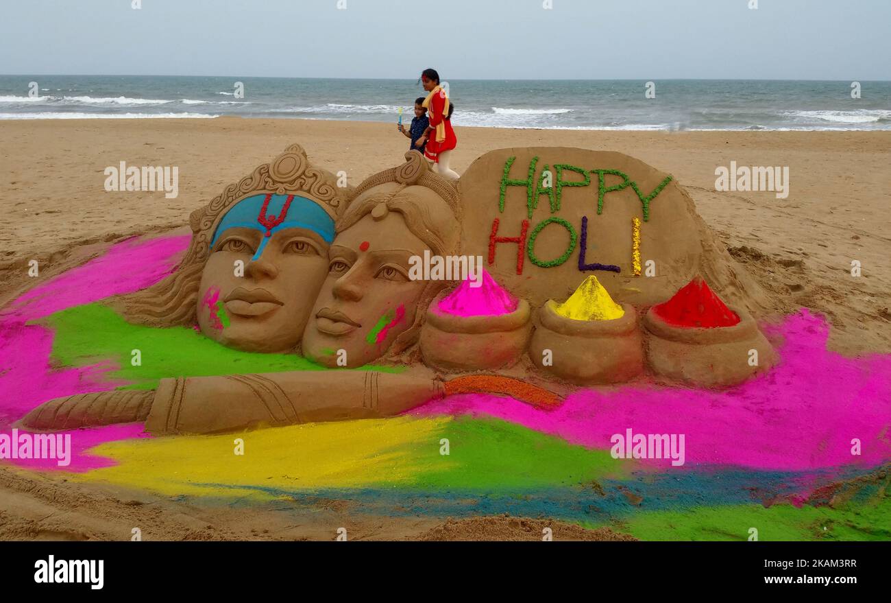 A sand sculpture gives message for the upcoming Holi festival ...