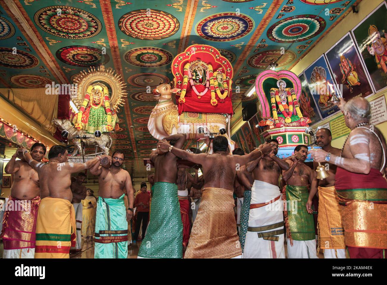 Tamil Hindu devotees take part in the procession as they carry the ...