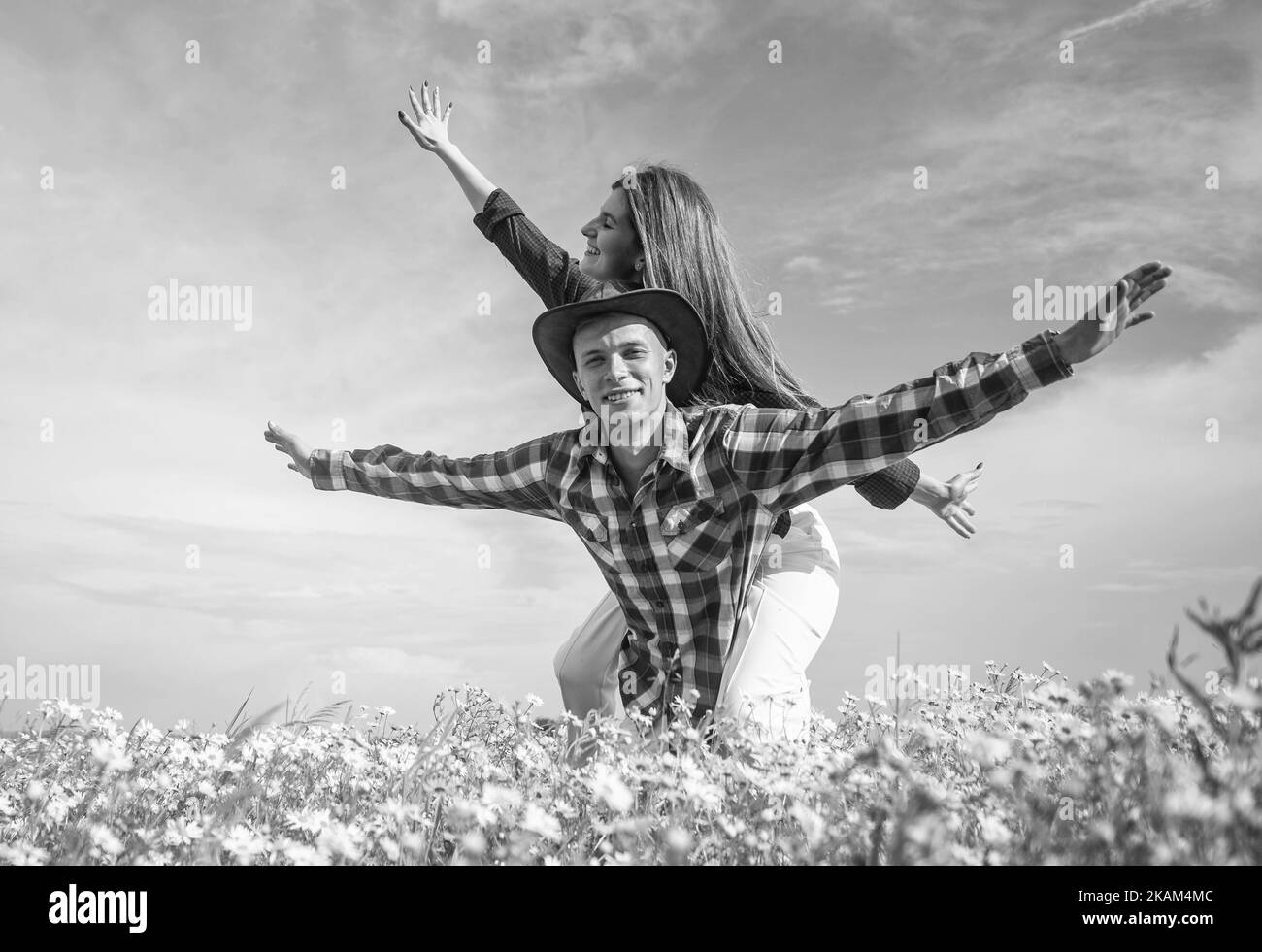 having fun. lovers in daisy flower field. couple in love. man and woman ...