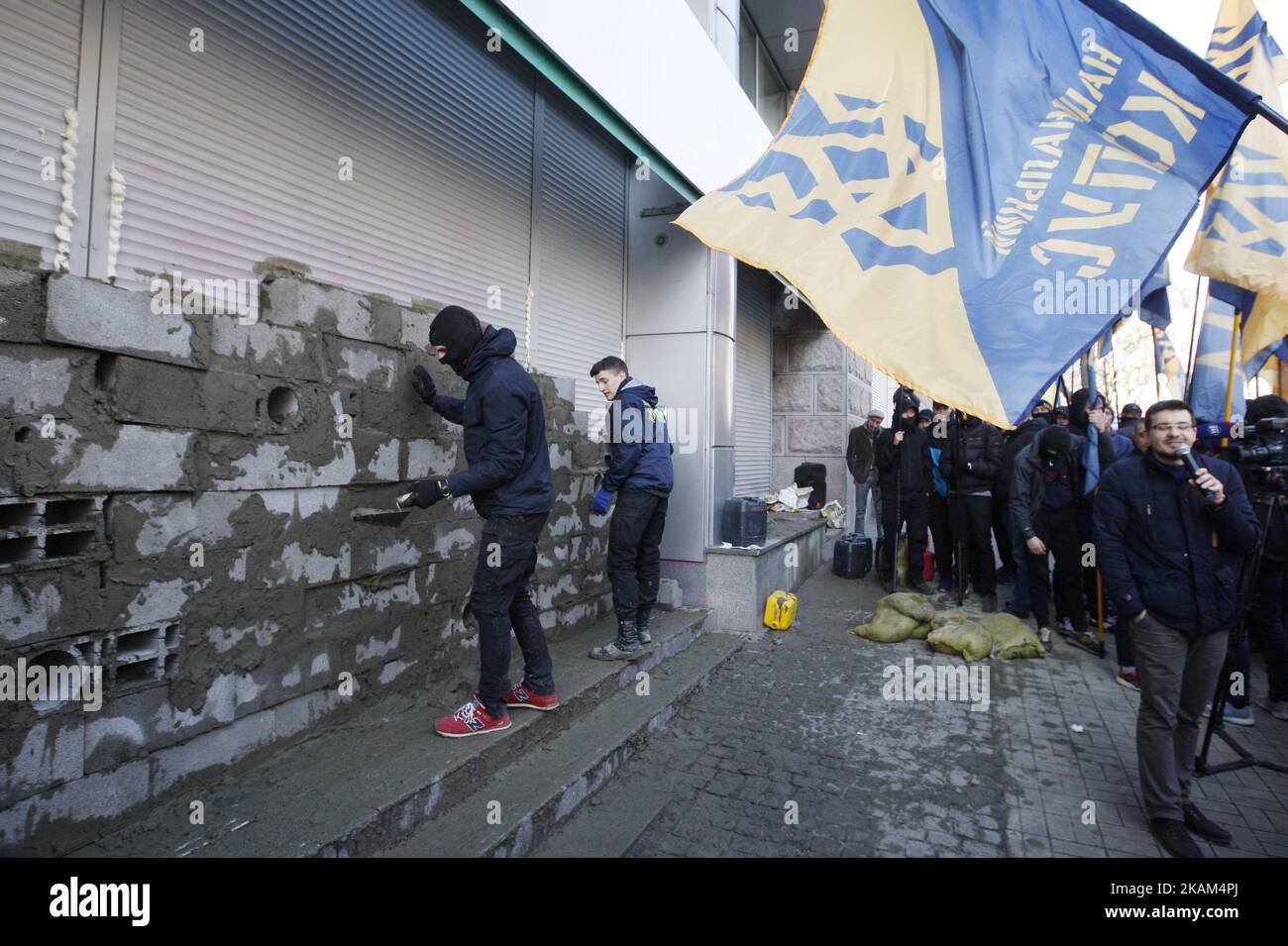 Ukrainian activists from National corps build a wall of cinder blocks ...