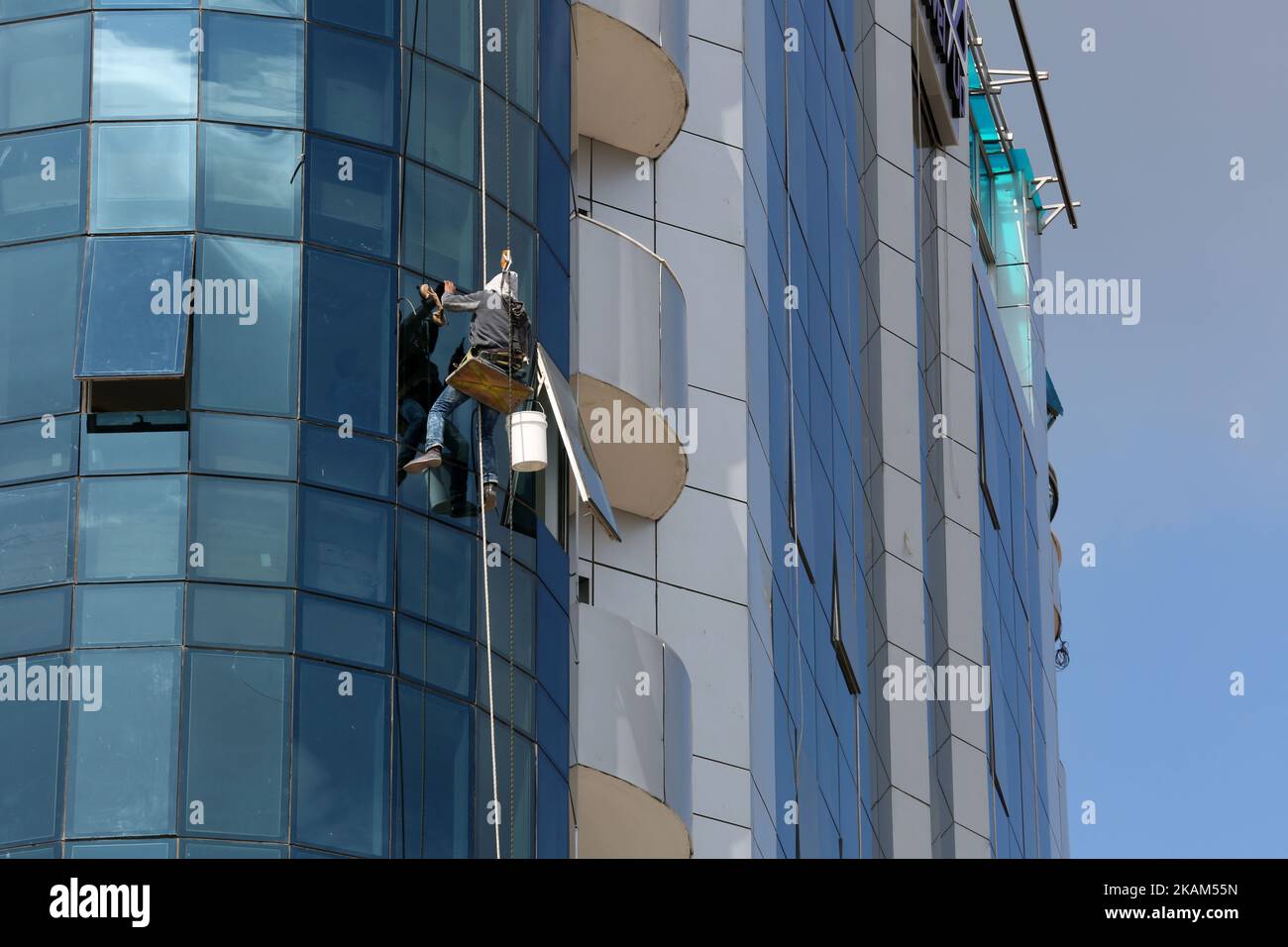 A Palestinian window cleaner works at the al-Zafer building in Gaza ...