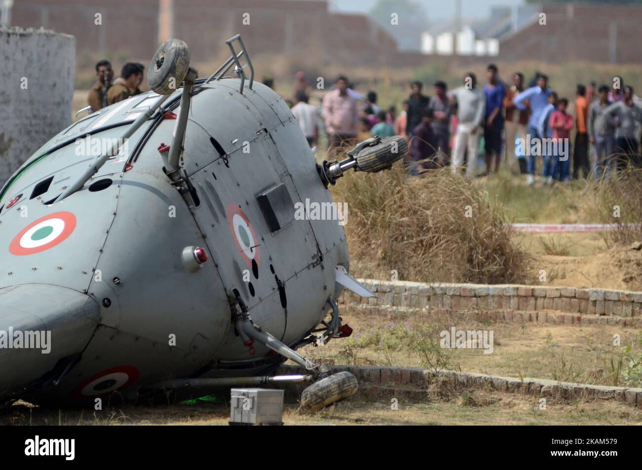 Indian local people gather near Indian air force crashed Chetak helicopter , in gauspur village ...
