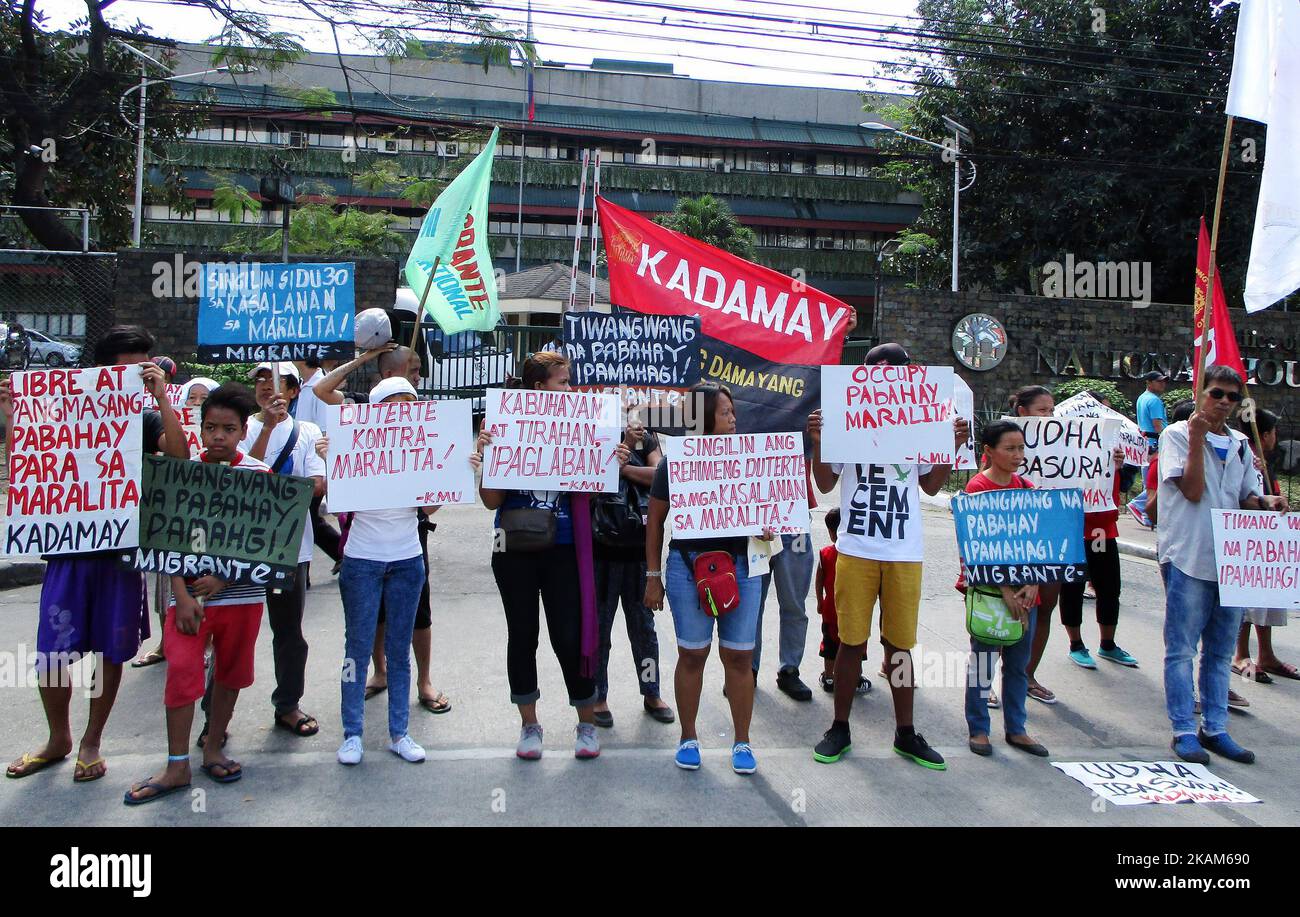 Protesters from an urban poor group hold placards outside the National ...
