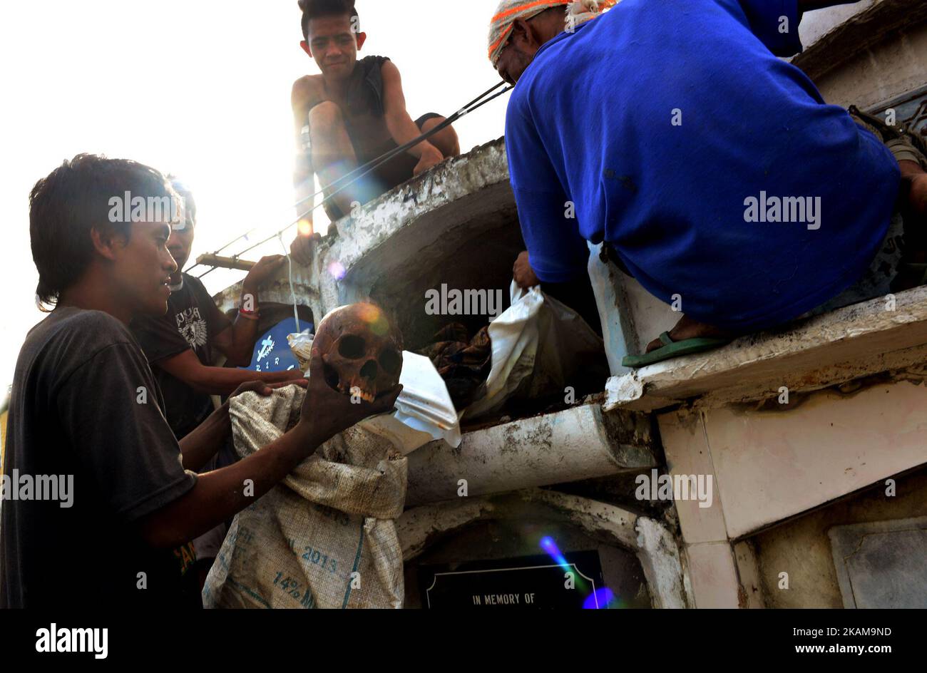 A group of men removes the skull and remnants of the body inside the ...