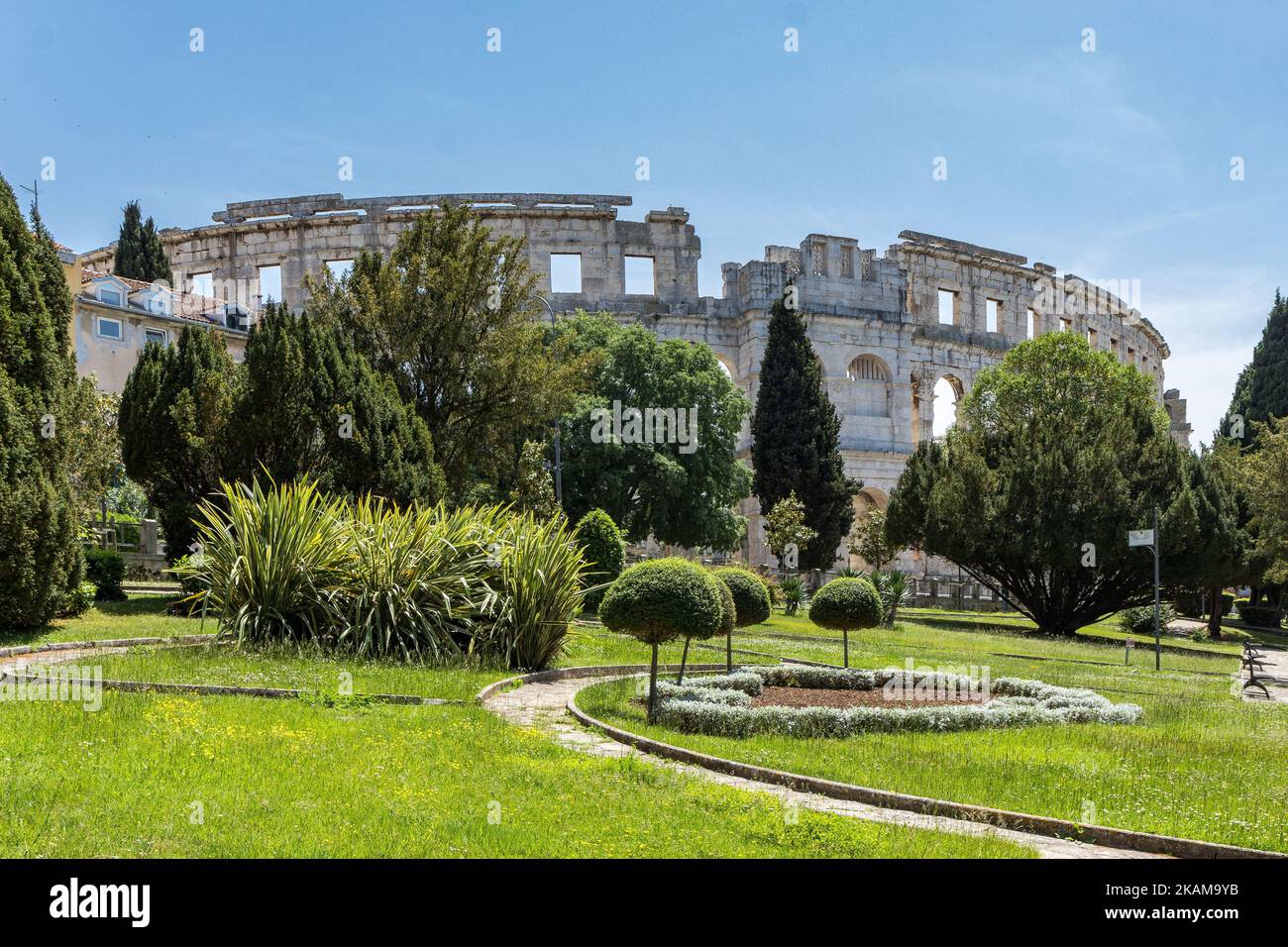 The Pula Arena building with a green tree garden in Croatia Stock Photo ...