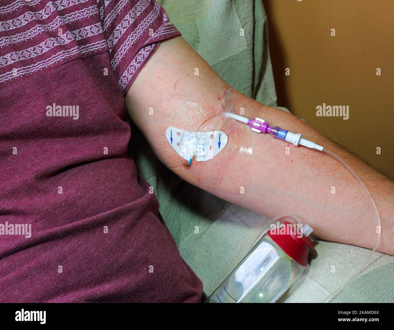 Senior or elderly man sitting in a chair at home and receiving ...